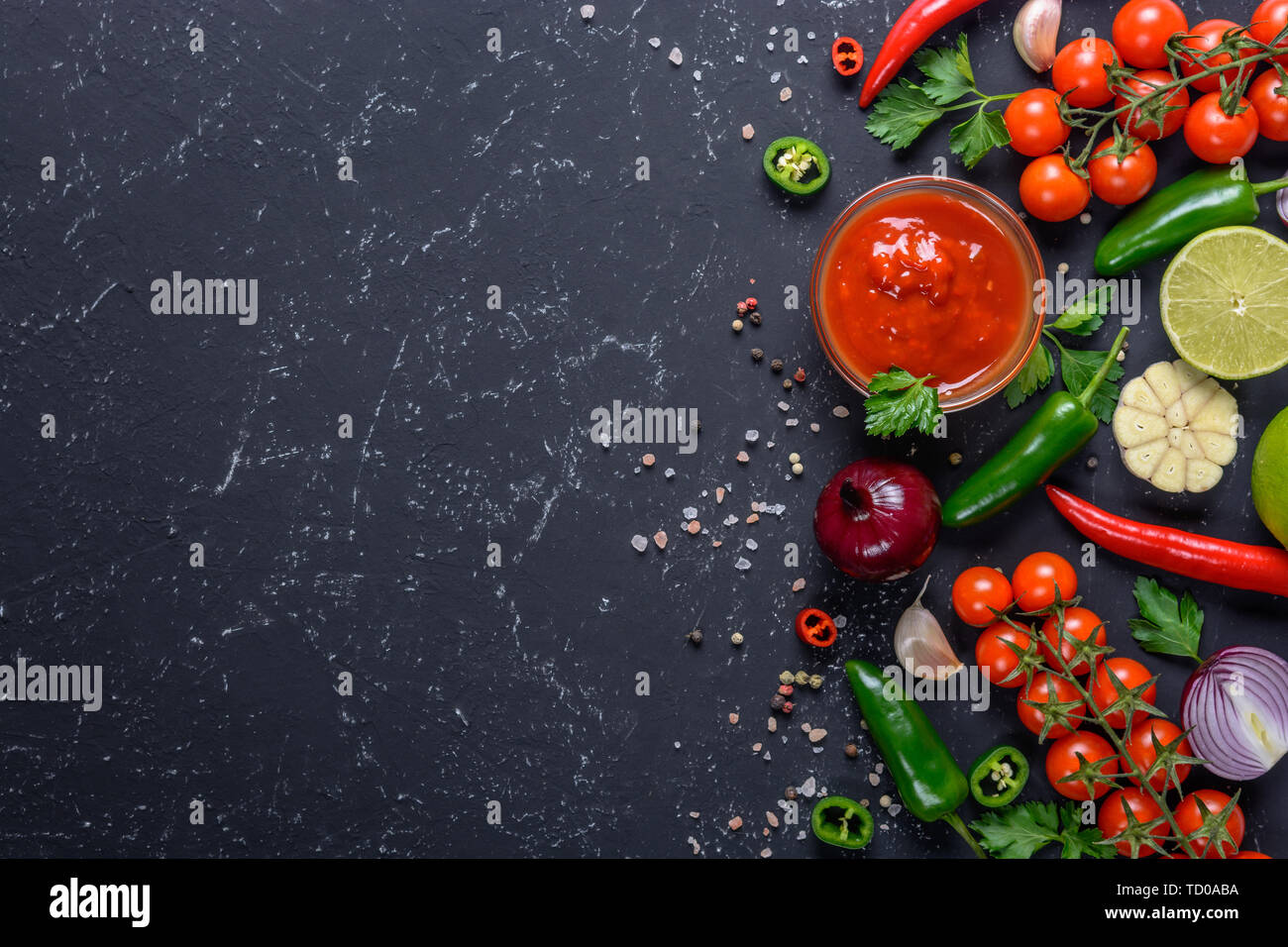 Traditional mexican salsa sauce and ingredients on black stone ...