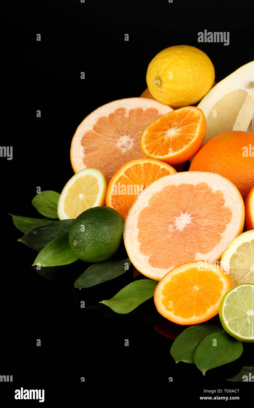 Lots ripe citrus isolated on black Stock Photo - Alamy