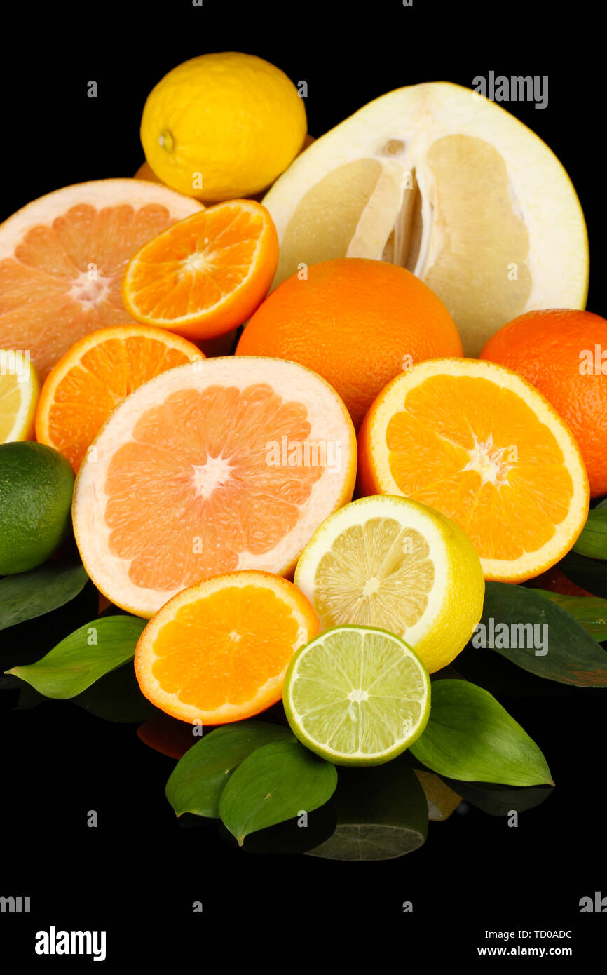 Lots ripe citrus isolated on black Stock Photo - Alamy