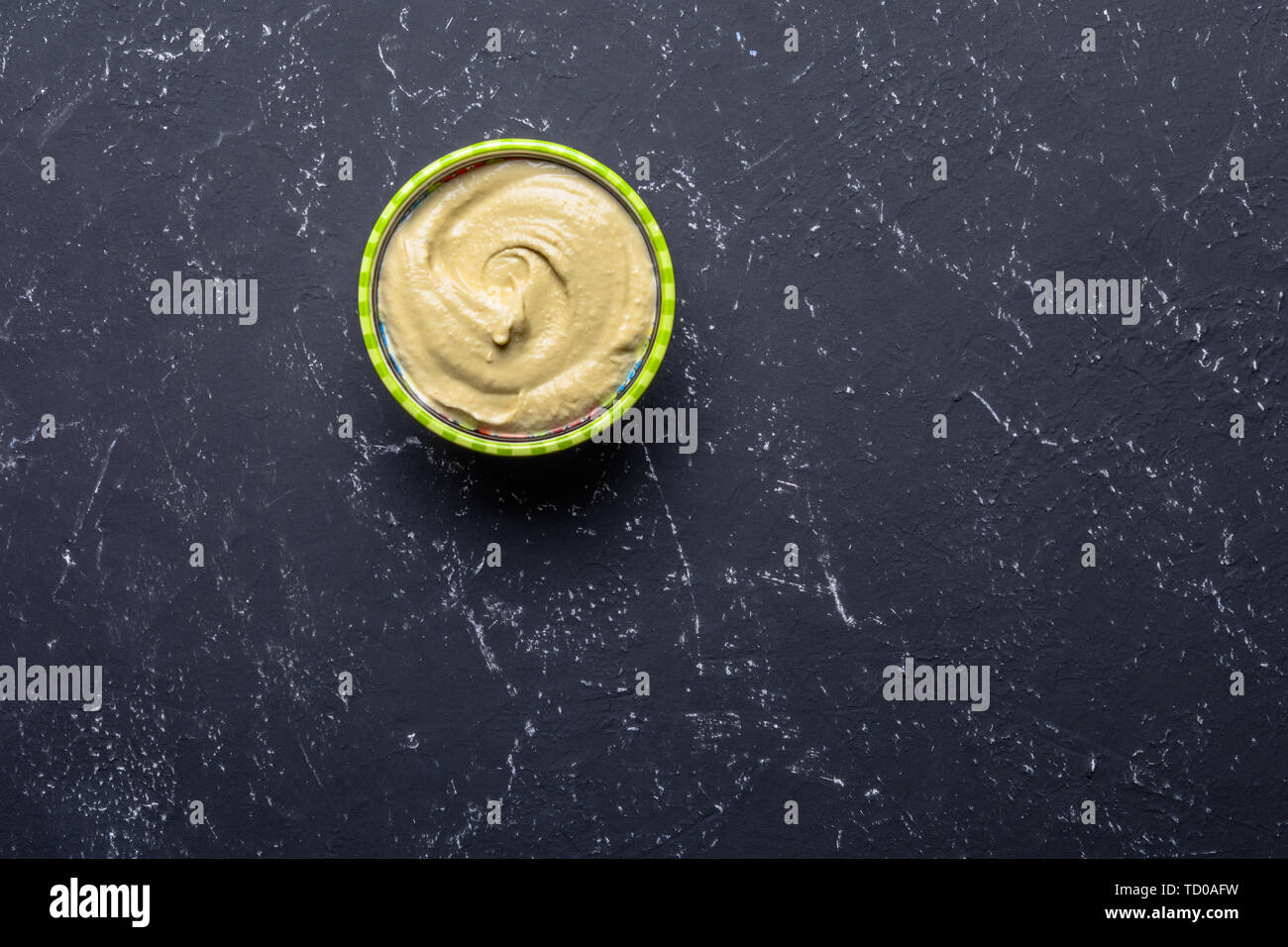 Hummus in a bowl on stone table. Top view with copy space Stock Photo ...