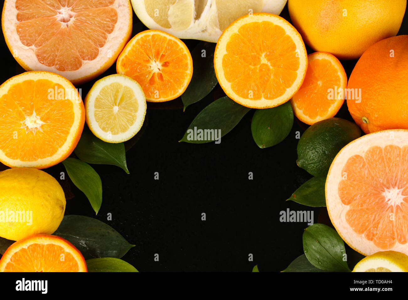 Lots ripe citrus isolated on black Stock Photo - Alamy