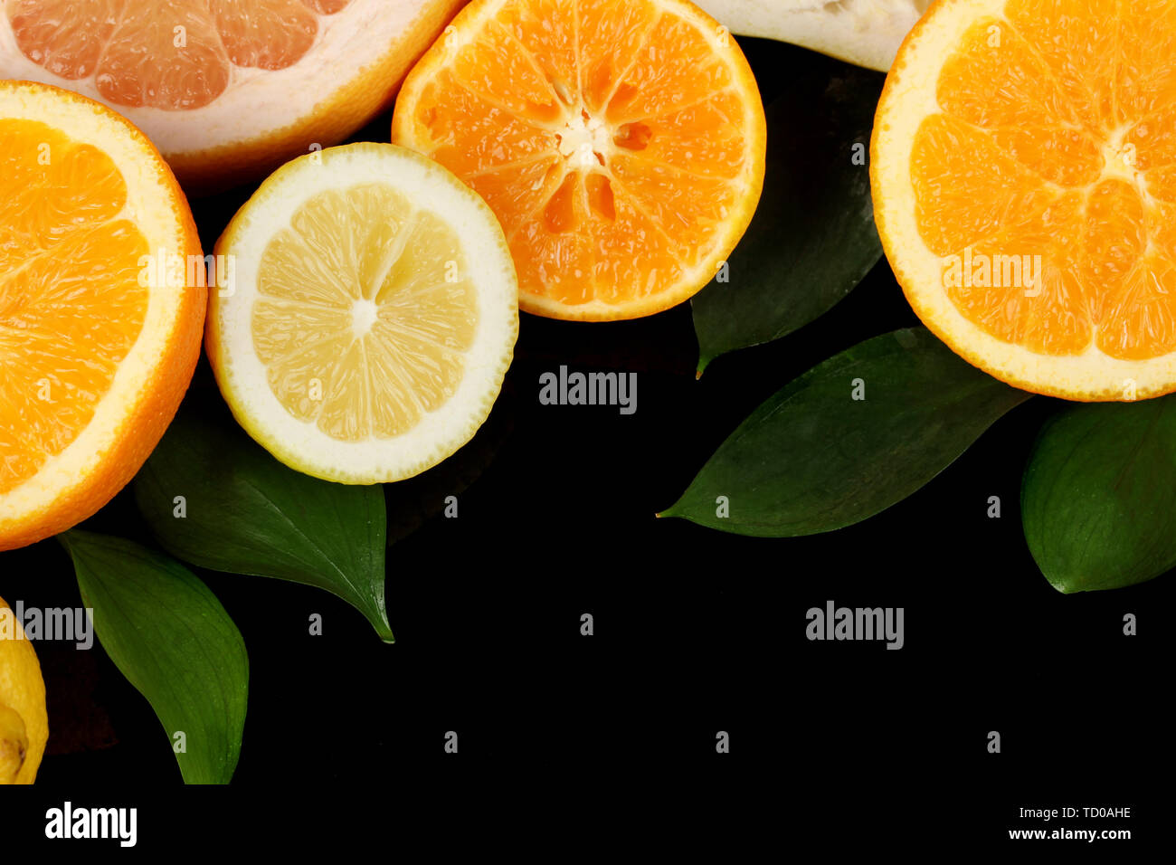 Lots ripe citrus isolated on black Stock Photo - Alamy