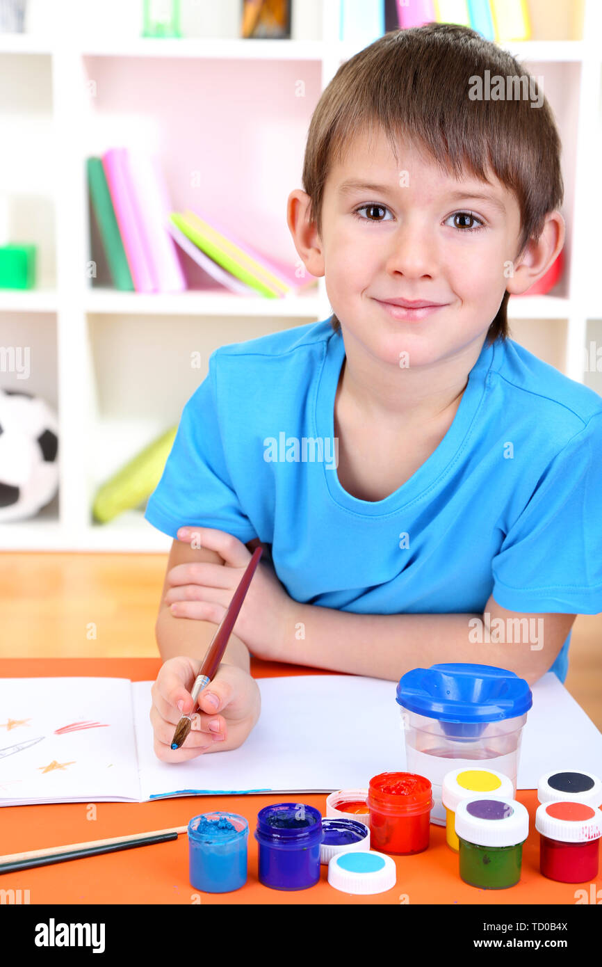 Cute little boy painting in his album Stock Photo - Alamy