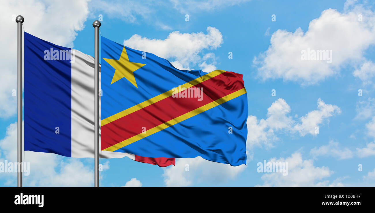 France and Congo flag waving in the wind against white cloudy blue sky ...
