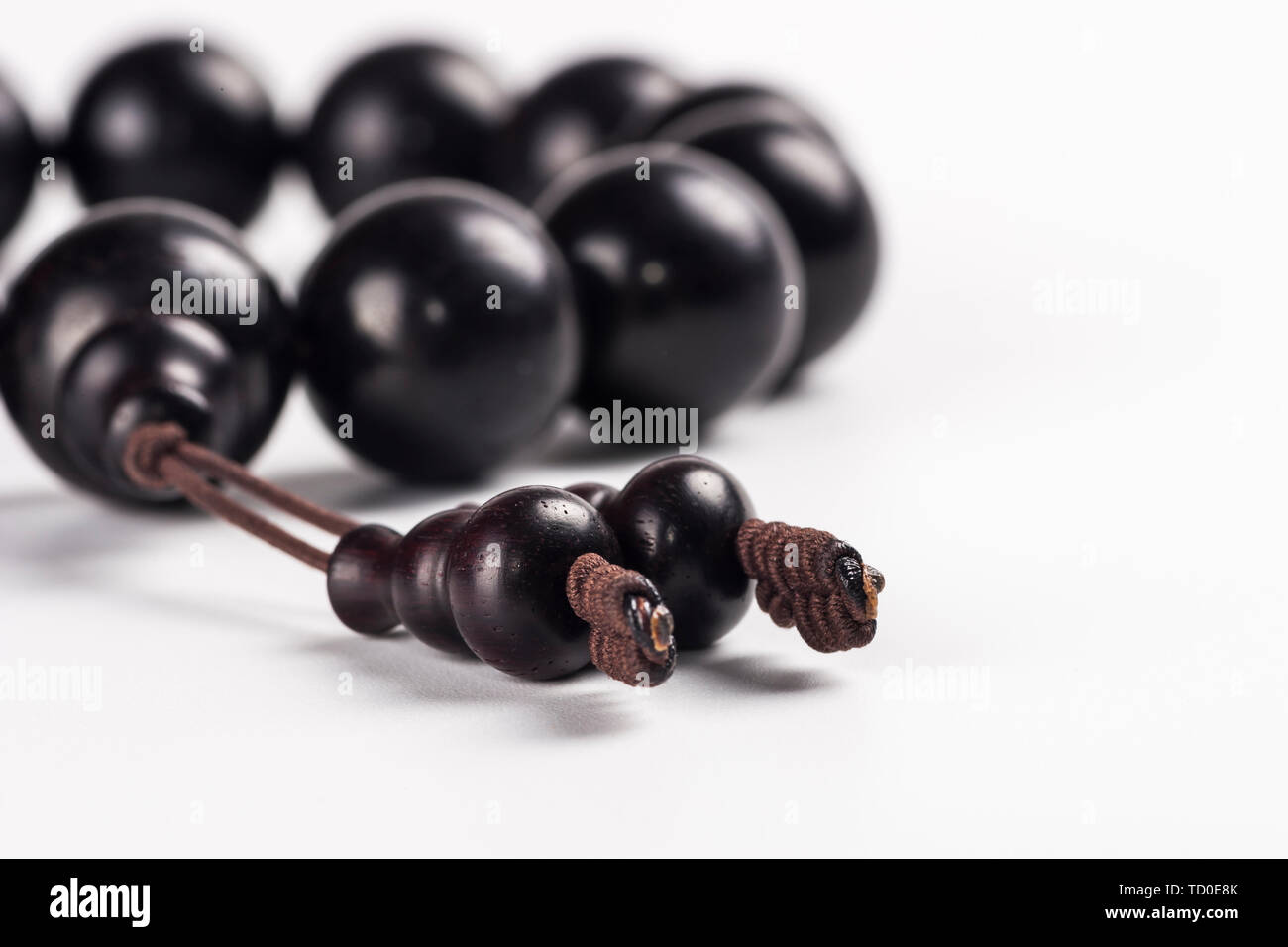 Hand string leaflet rosewood beads Stock Photo - Alamy