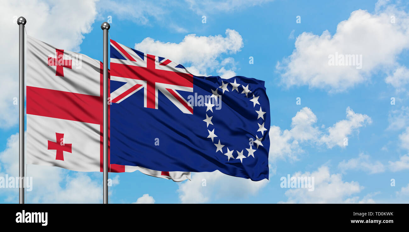Georgia and Cook Islands flag waving in the wind against white cloudy ...