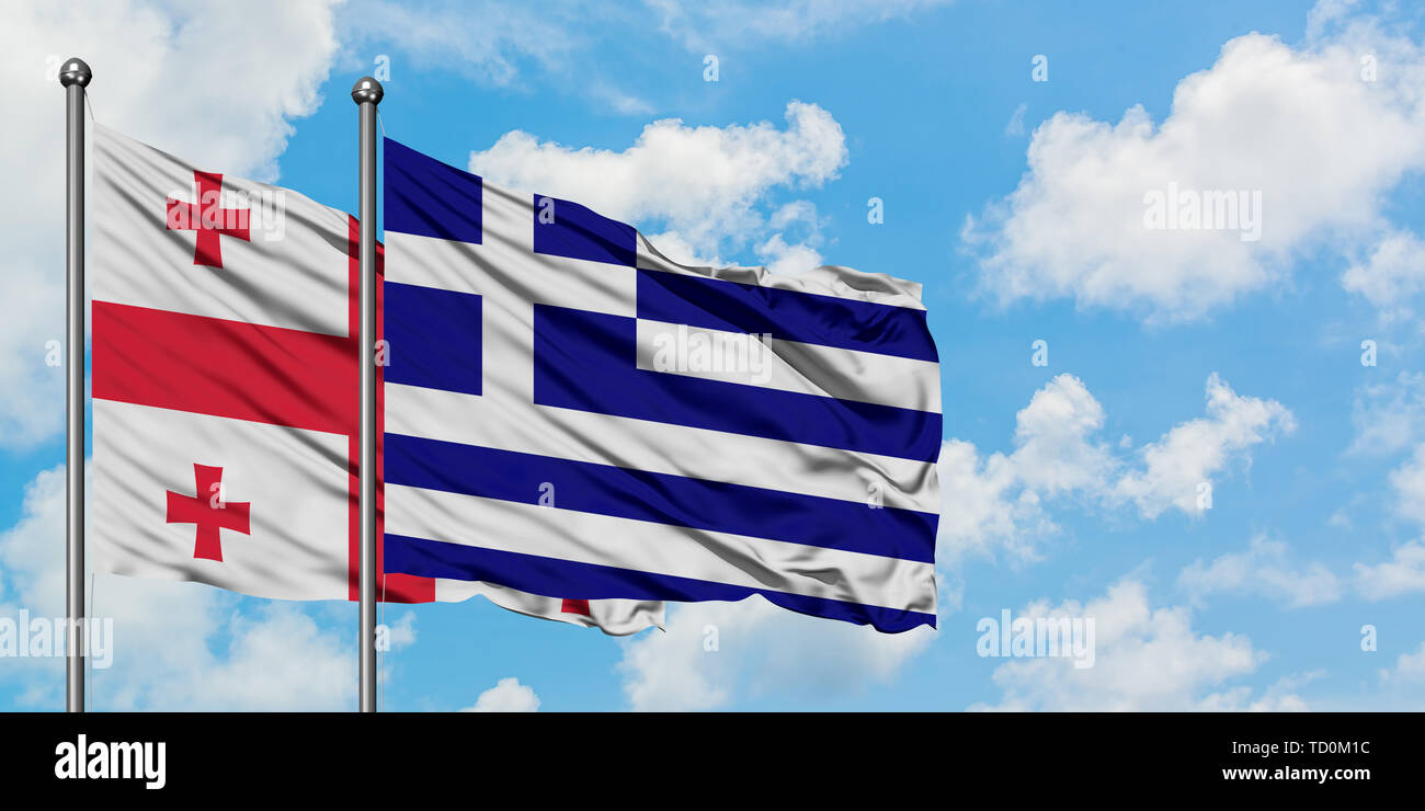Georgia and Greece flag waving in the wind against white cloudy blue ...
