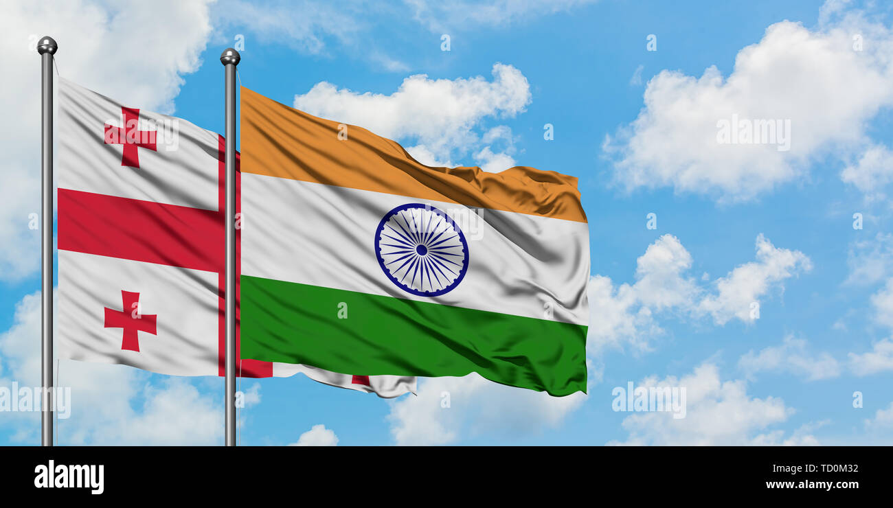 Georgia and India flag waving in the wind against white cloudy blue sky ...