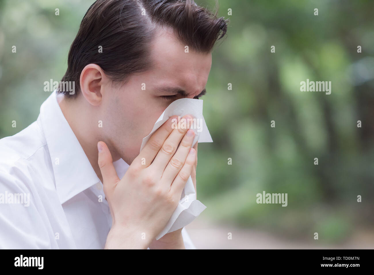 Man uses tissue paper sneezing due to having pollen allergy Stock Photo ...