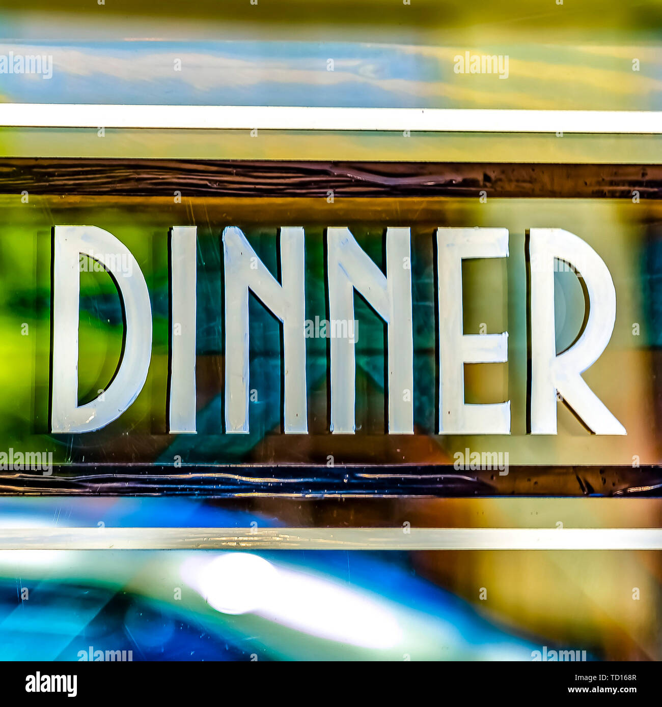 Square Close up view of the glass wall of a restaurant with a Dinner ...