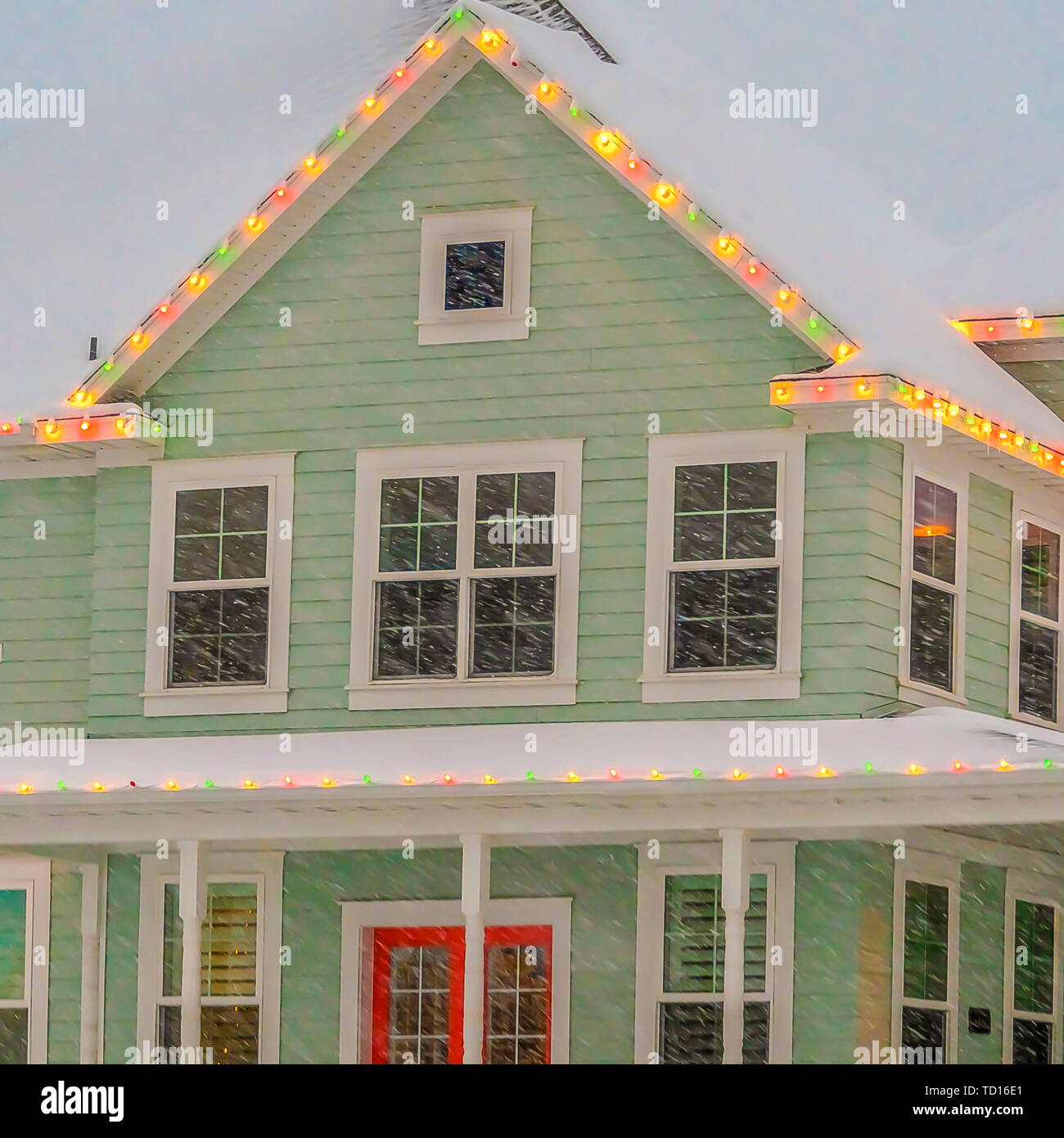 Square Facade of a house with green exterior wall and wide front porch ...
