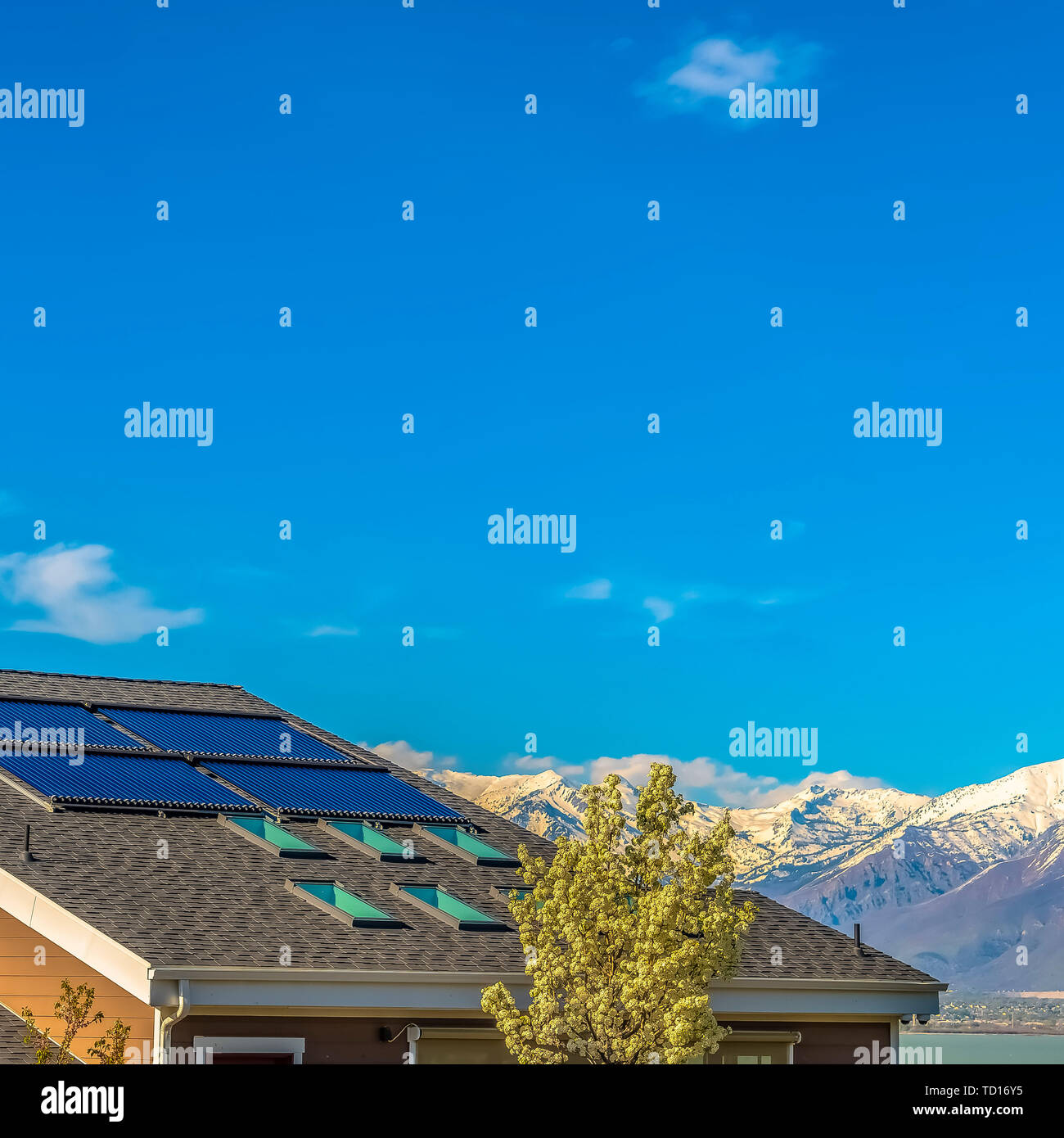 Square frame Roof with solar panels and skylights against lake and ...