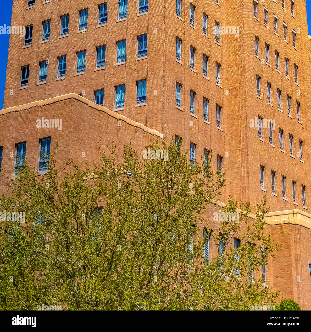 Square frame Building exterior with brick wall and rectangular windows ...