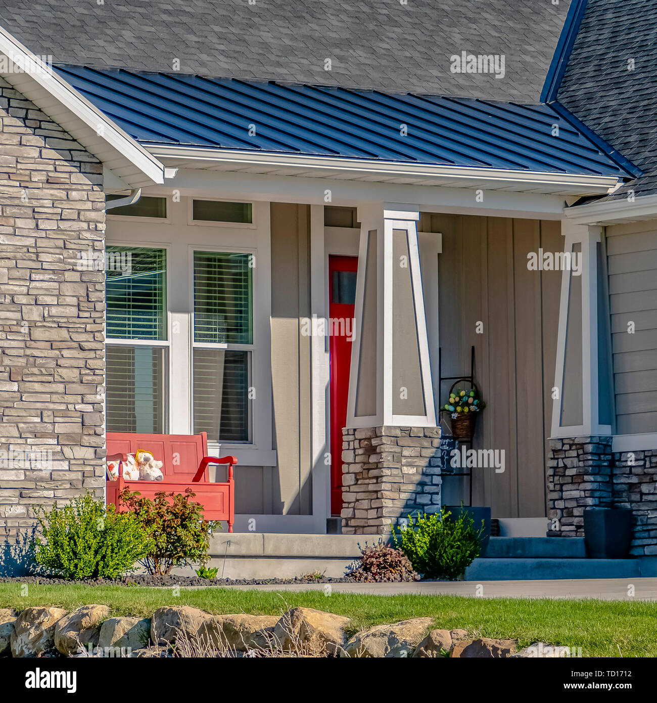Square frame Facade of a home with stone brick wall and small porch ...