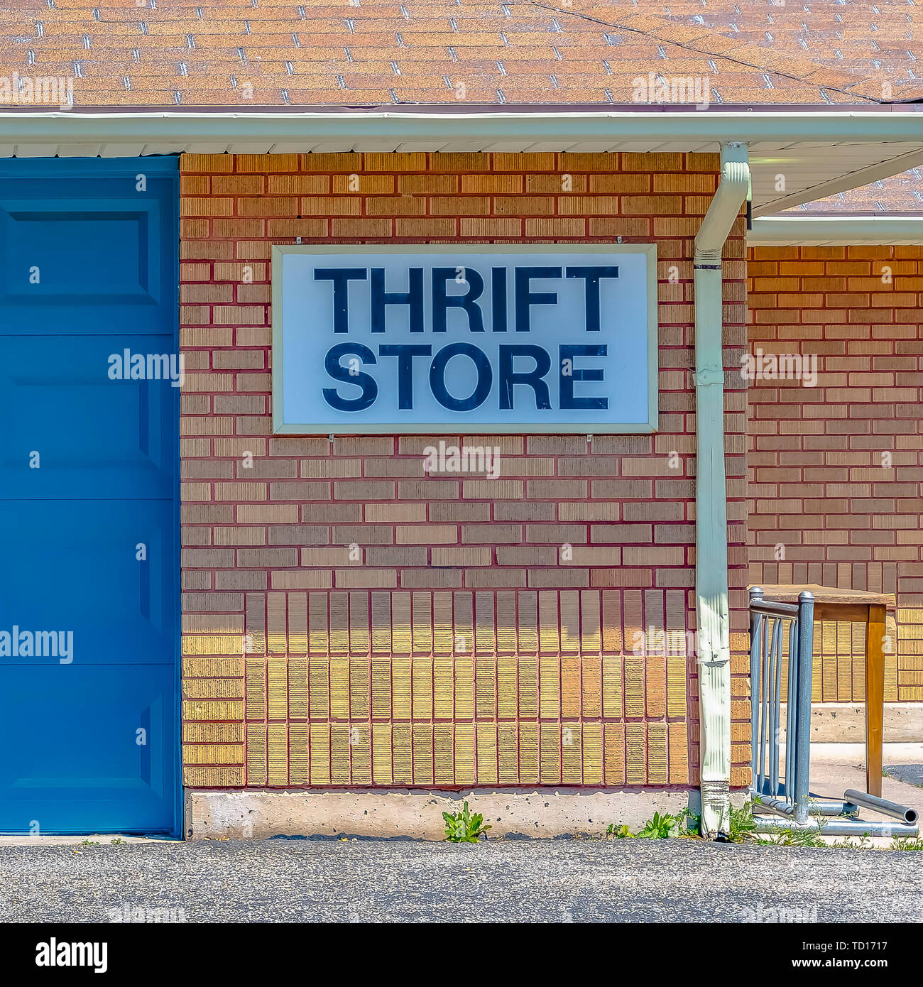 Square Building with pitched roof and large blue door viewed on a sunny ...