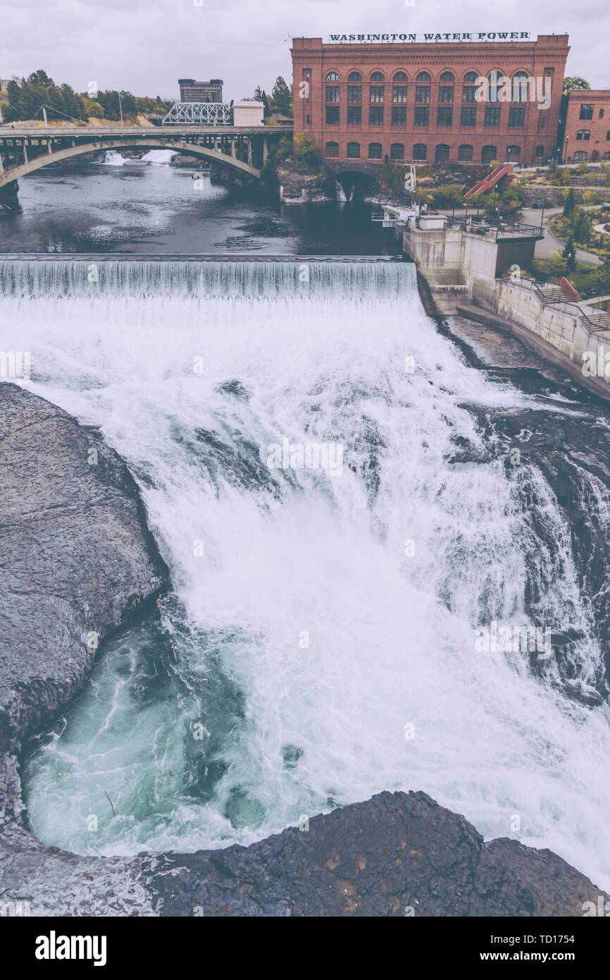 Beautiful river running under a bridge in an urban city Stock Photo - Alamy
