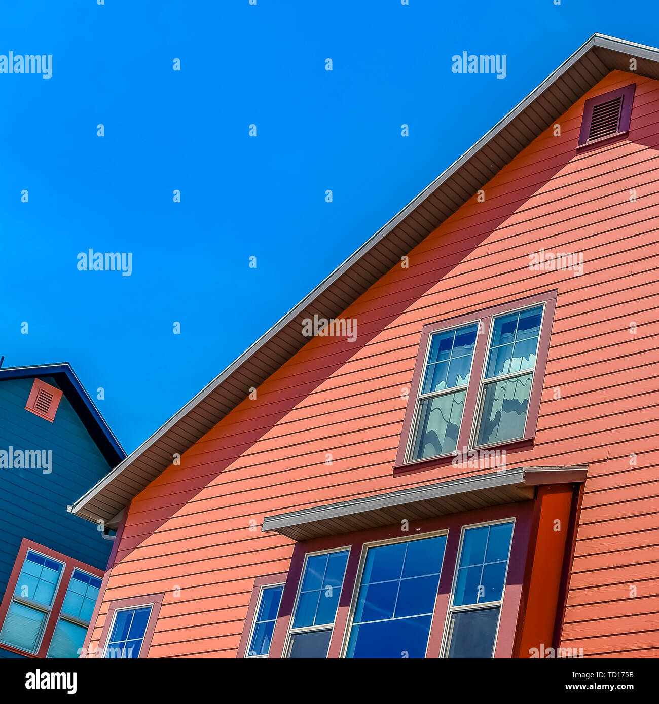 Square Exterior of home with a combination of red wood section and ...