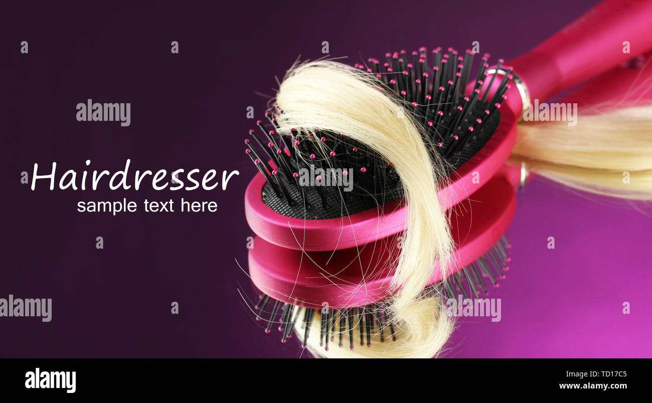 Comb brush with hair on purple background Stock Photo - Alamy