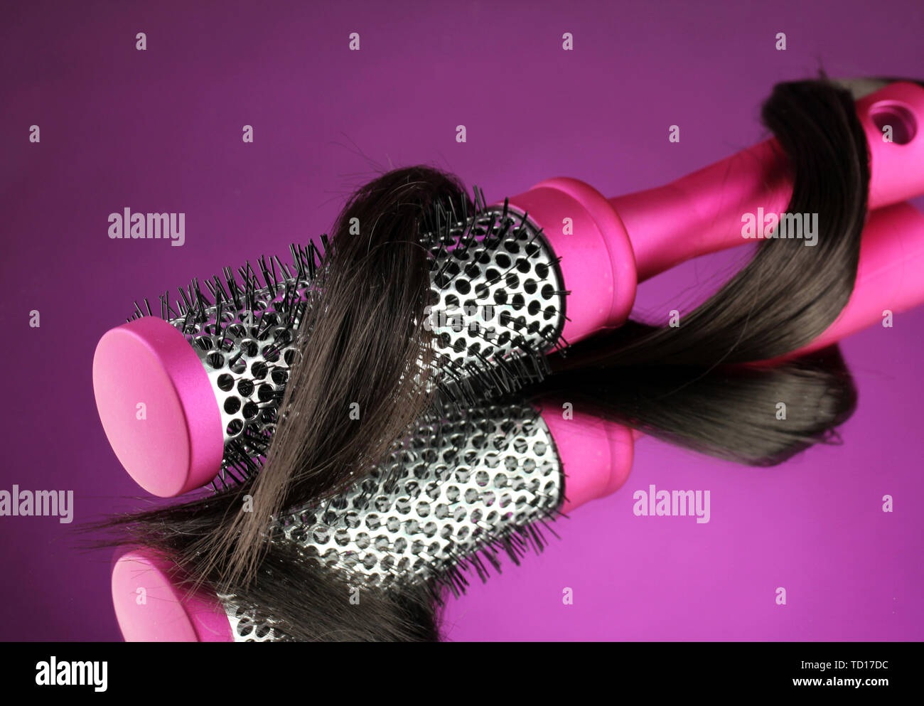 Comb brush with hair on purple background Stock Photo - Alamy