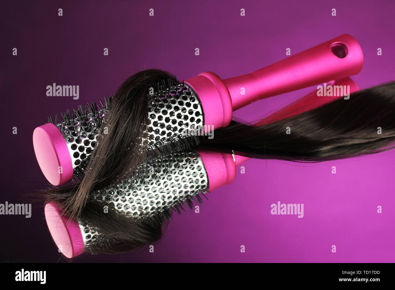 Comb brush with hair on purple background Stock Photo - Alamy