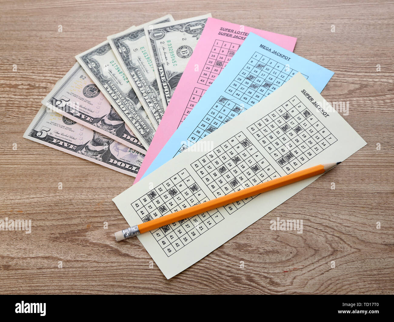 Lottery tickets with pencil and money, on wooden background Stock Photo ...
