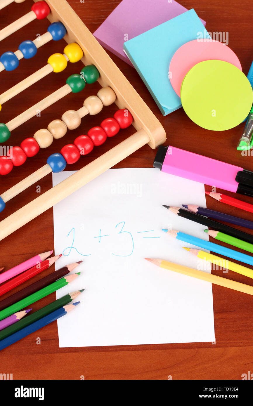 Toy abacus, note paper, pencils on bright background Stock Photo - Alamy
