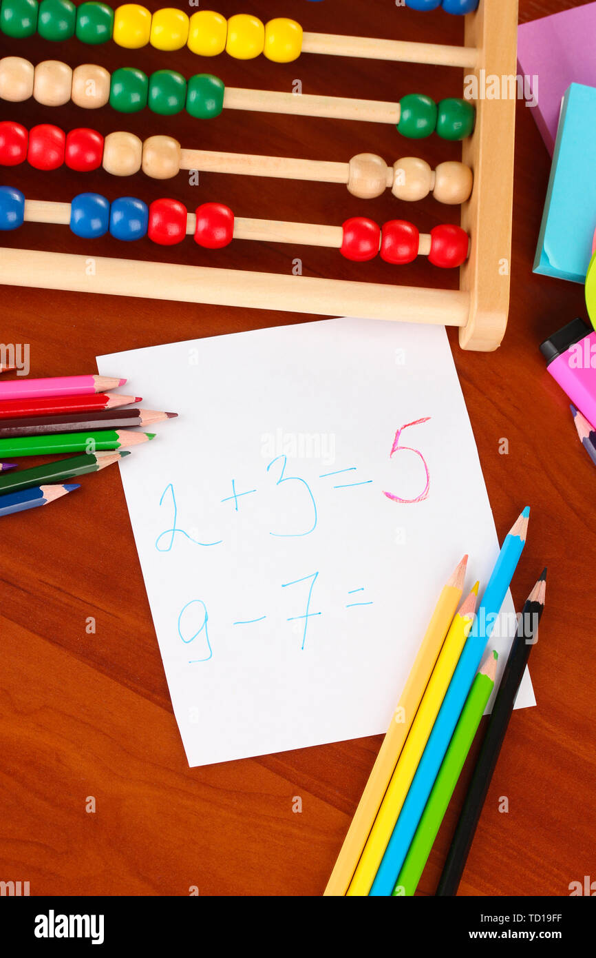 Toy abacus, note paper, pencils on bright background Stock Photo - Alamy