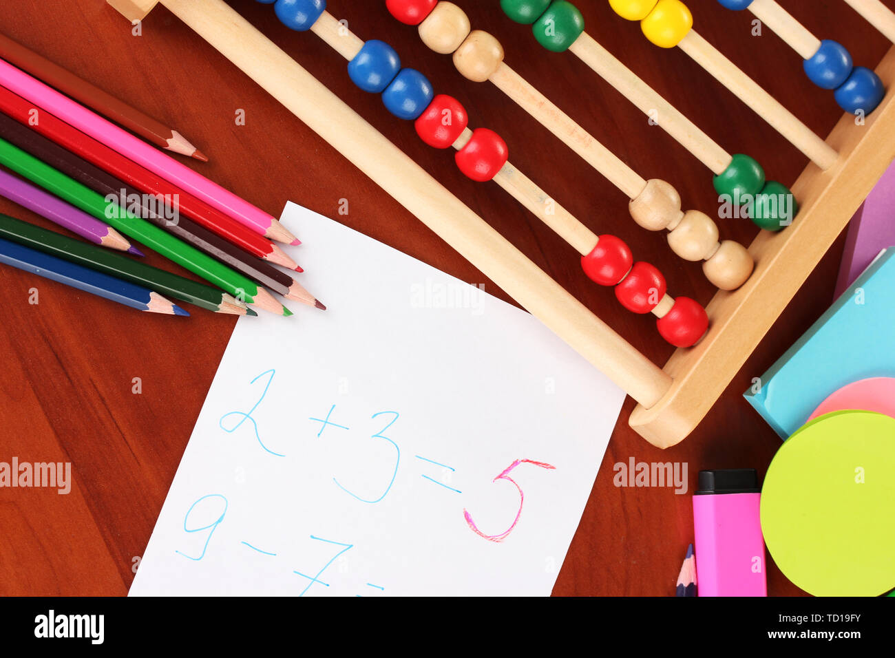 Toy abacus, note paper, pencils on bright background Stock Photo - Alamy