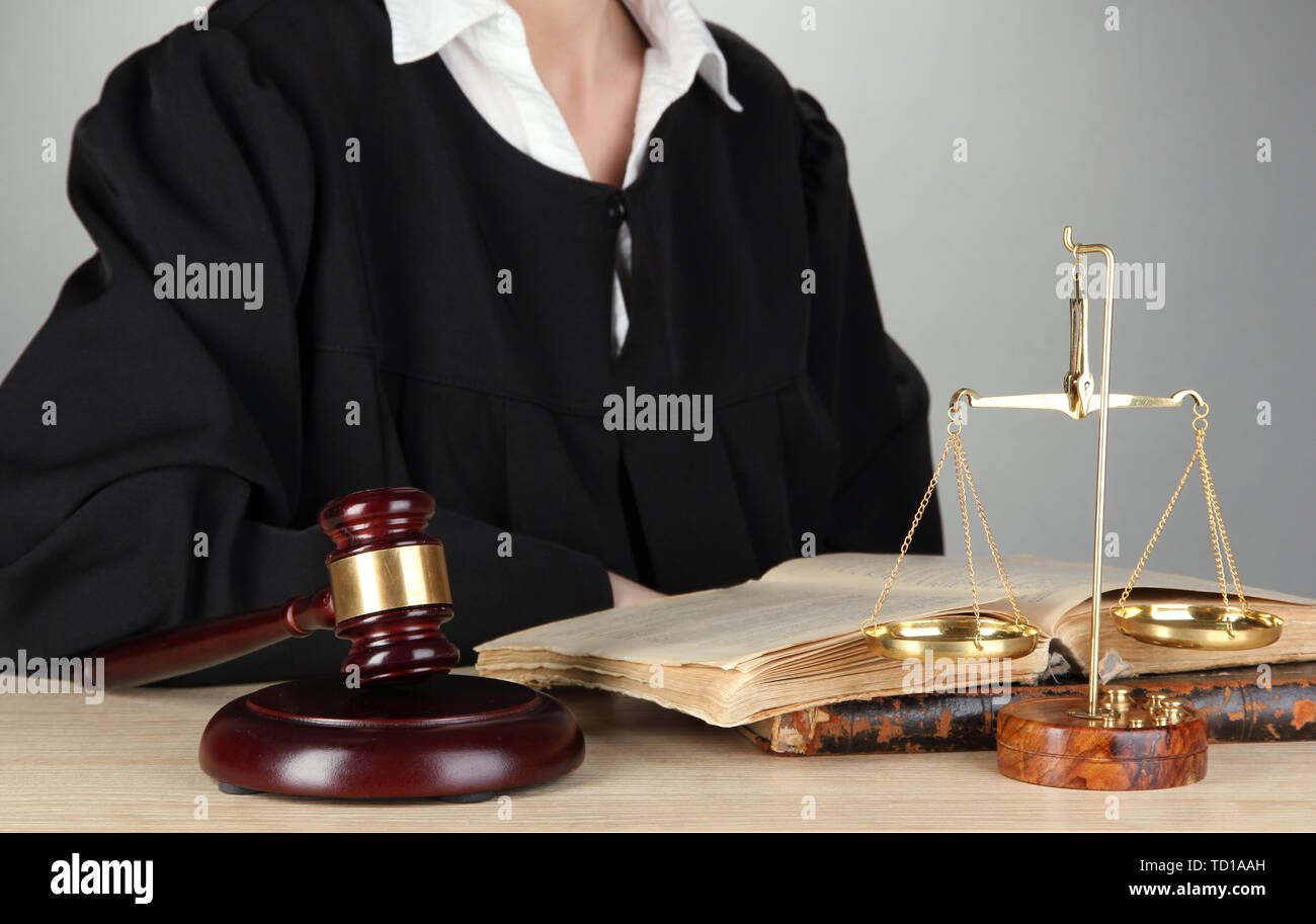 Judge sitting at table during court hearings on grey background Stock ...