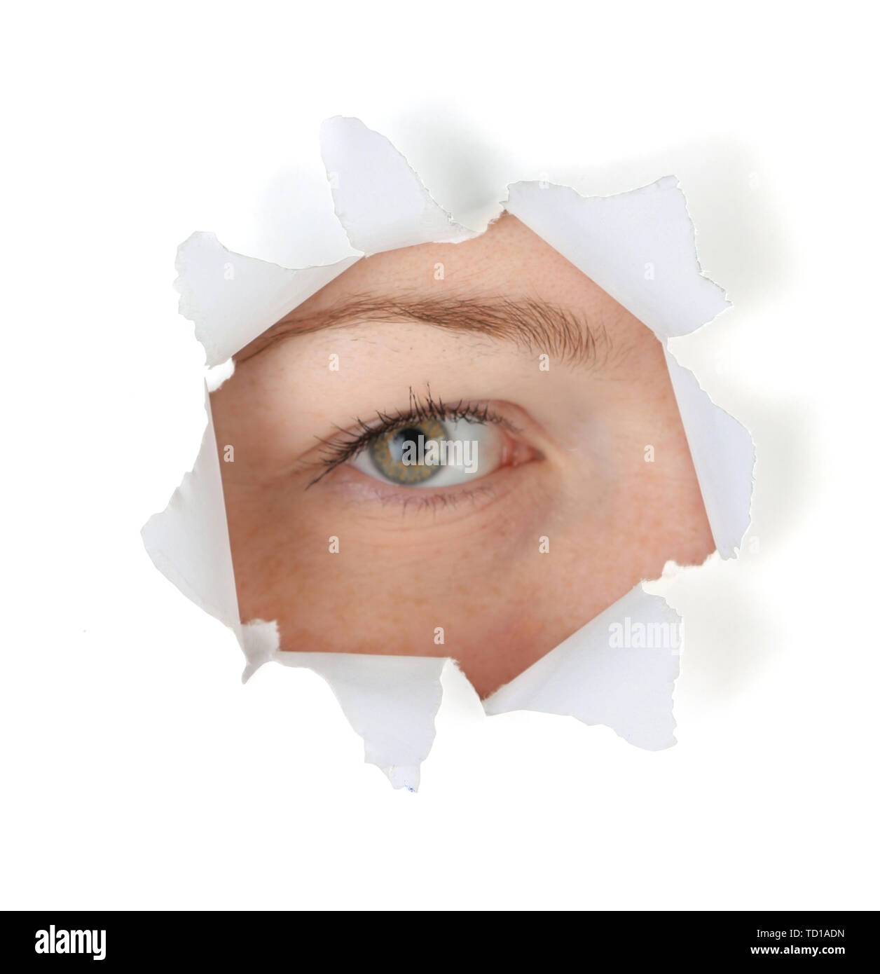 Female eye looking through hole in sheet of paper Stock Photo - Alamy