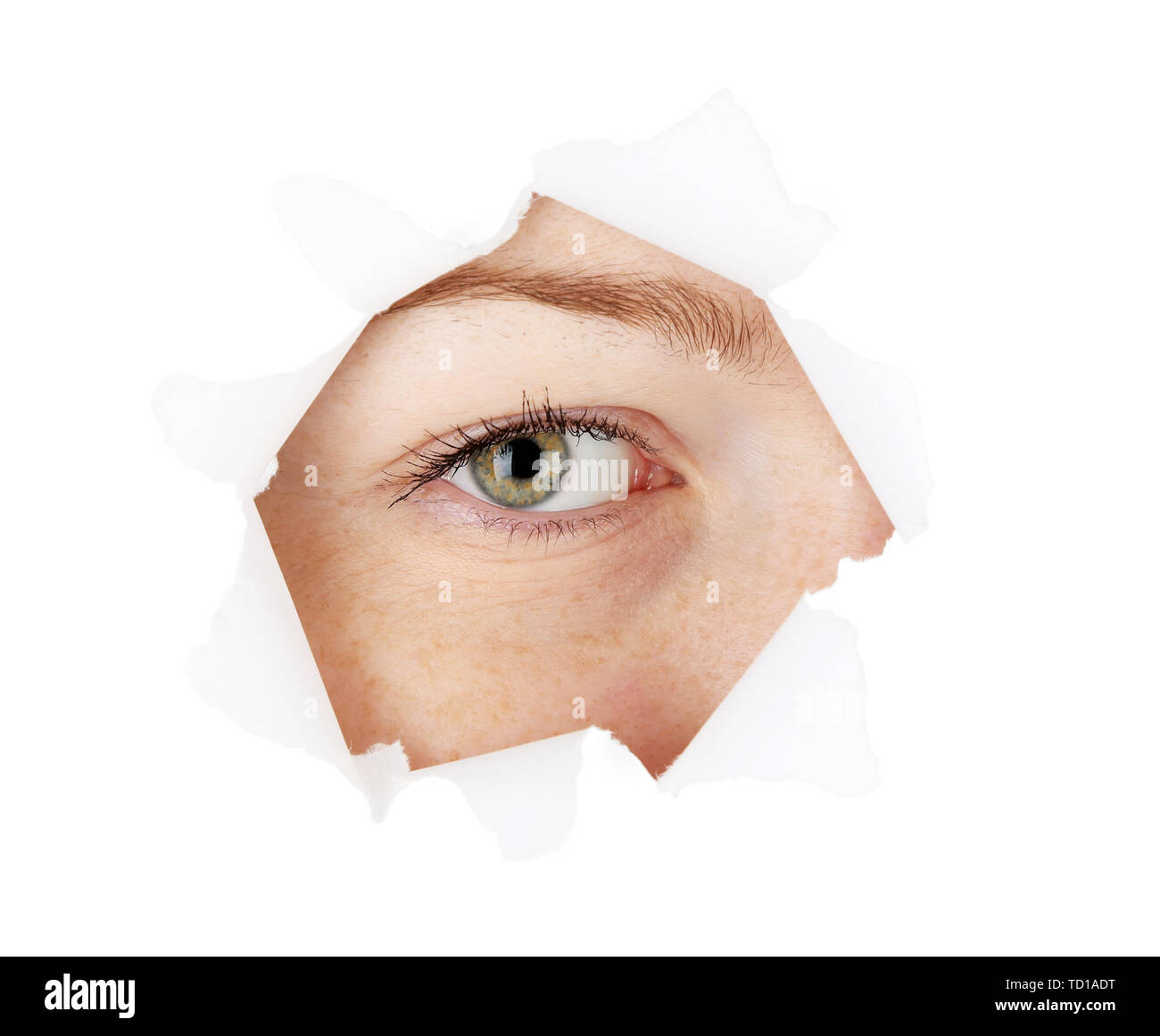 Female eye looking through hole in sheet of paper Stock Photo - Alamy