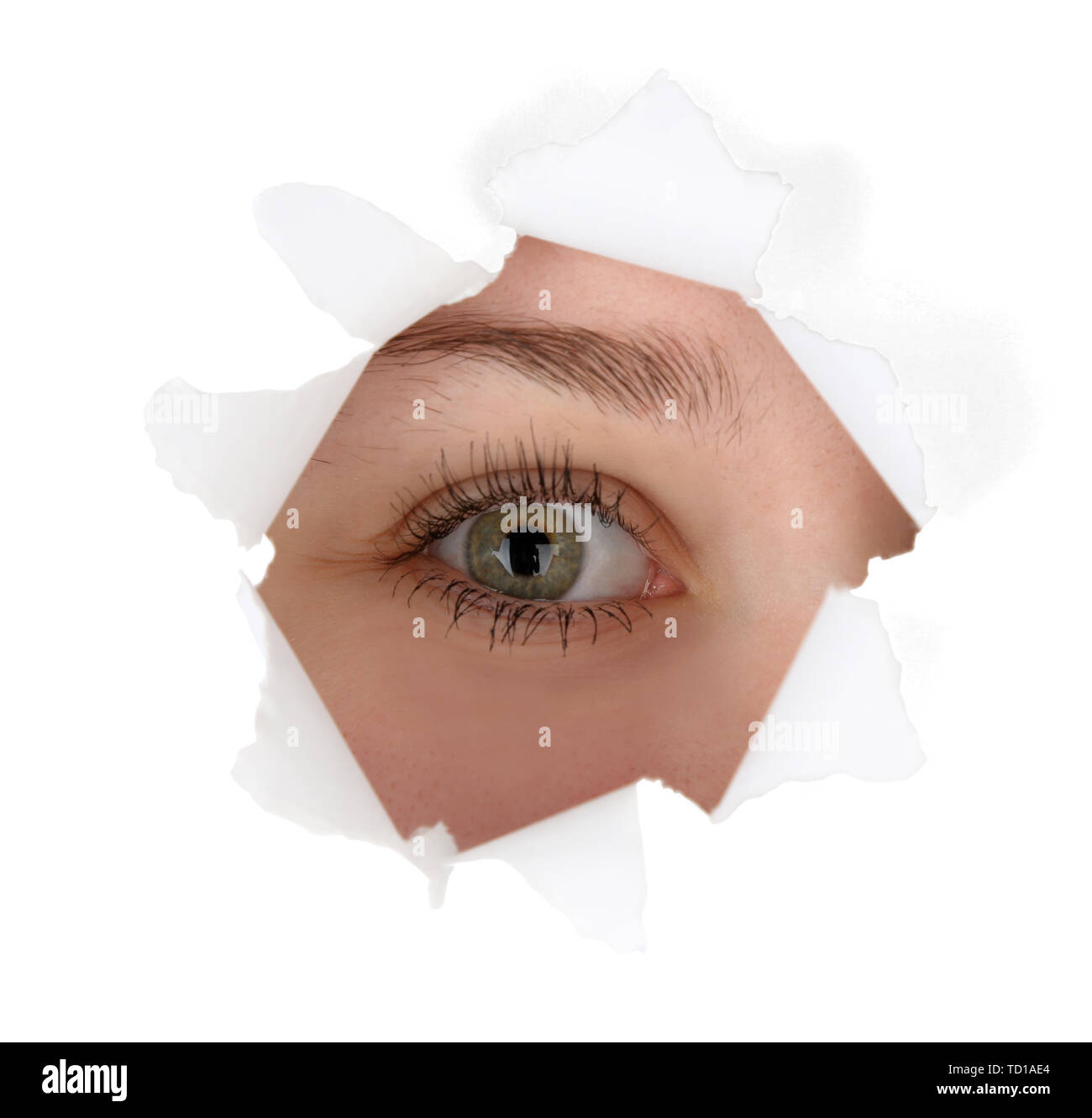 Female eye looking through hole in sheet of paper Stock Photo - Alamy