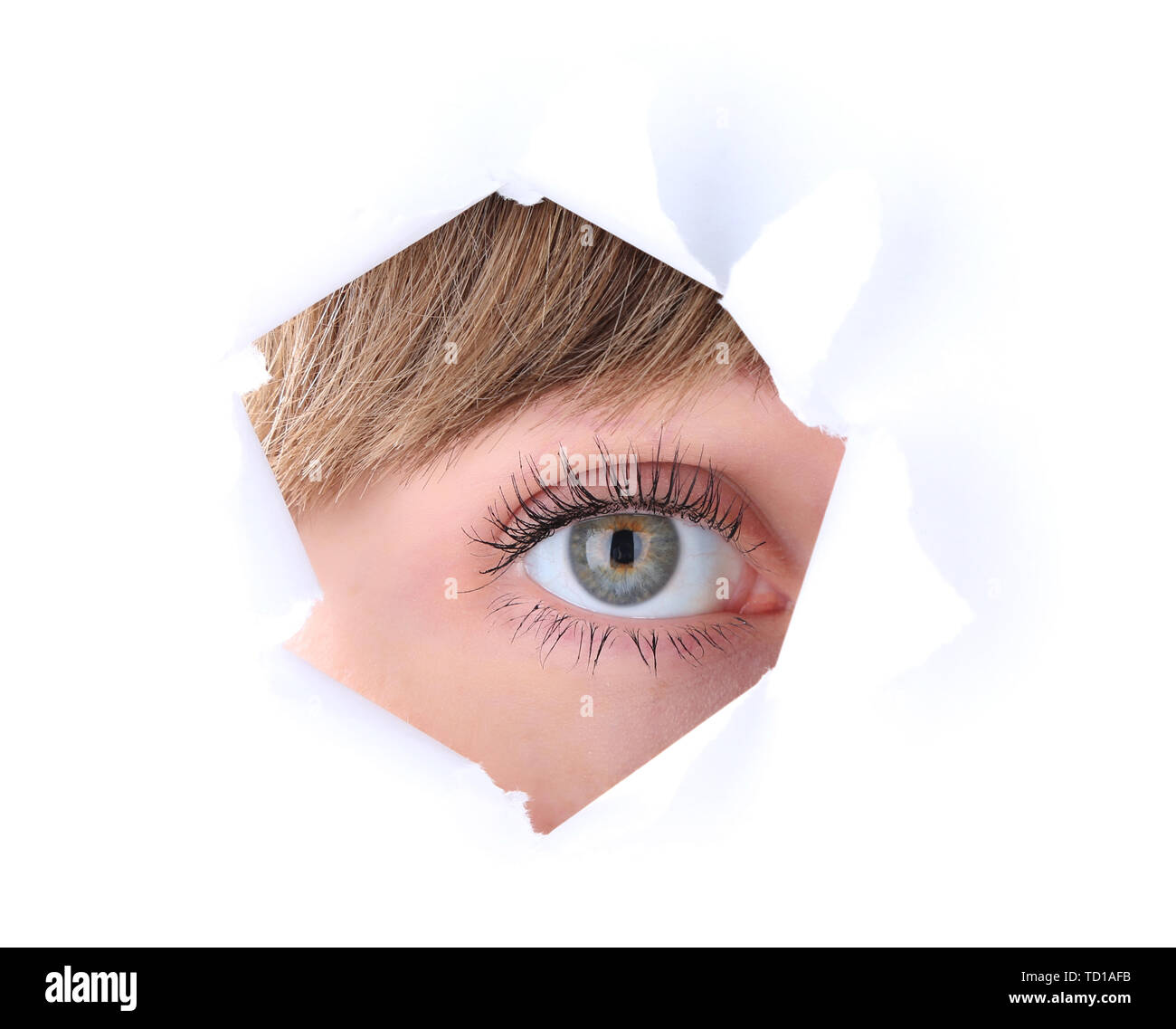 Female eye looking through hole in sheet of paper Stock Photo - Alamy
