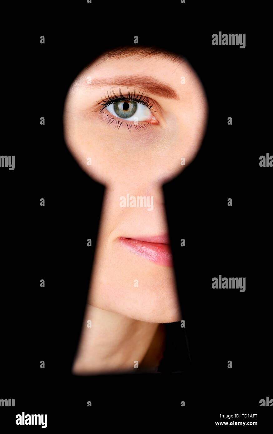 Woman eye looking through hole in keyhole, on black background Stock ...
