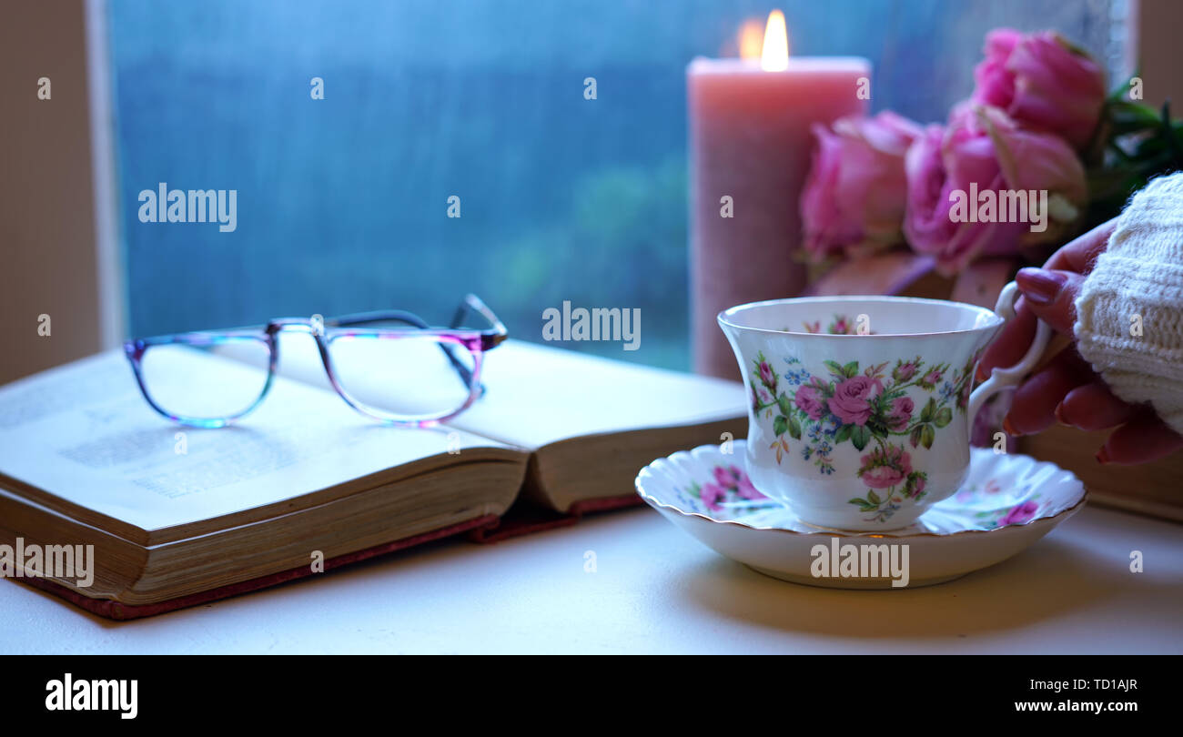 Nostalgia scene relaxing by the window on a cold rainy day with old ...