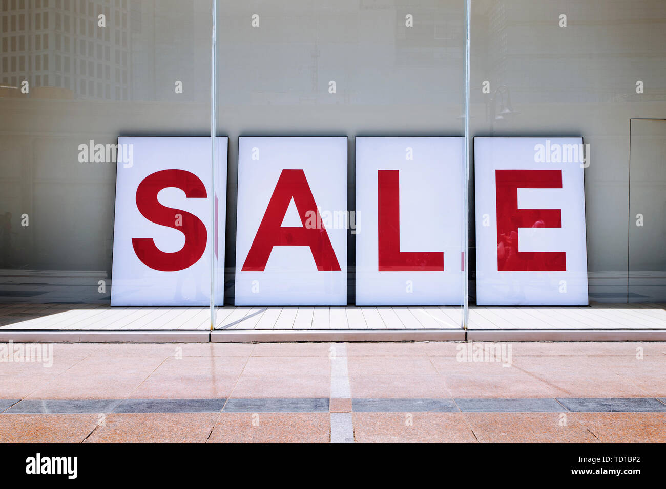 Sale poster in shop display window Stock Photo - Alamy