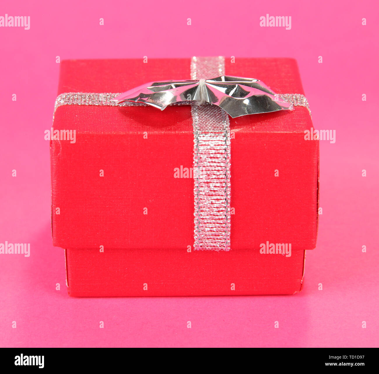 Color gift box with silver ribbon, on color background Stock Photo - Alamy