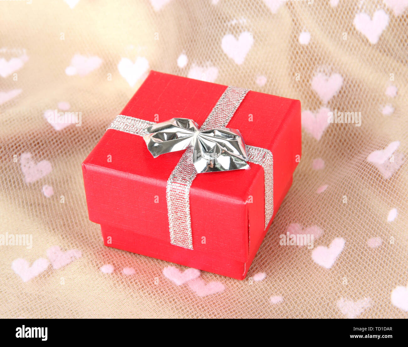 Color gift box with silver ribbon, on color background Stock Photo - Alamy