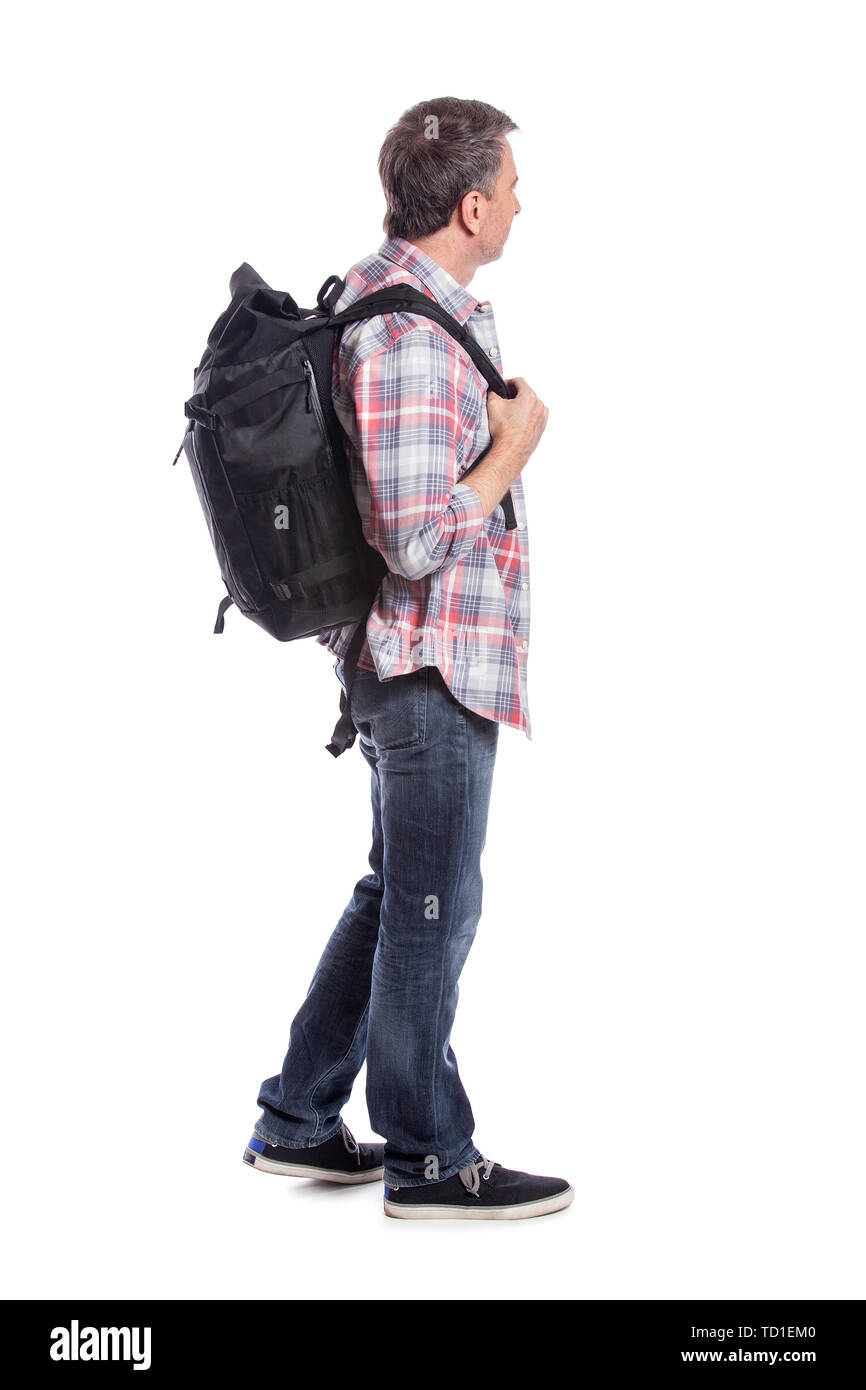 Middle-aged man hiking and carrying a backpack on a white background ...