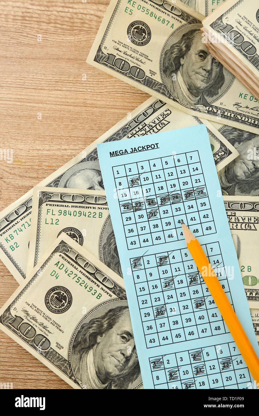 Lottery ticket,money and pencil on wooden background Stock Photo - Alamy