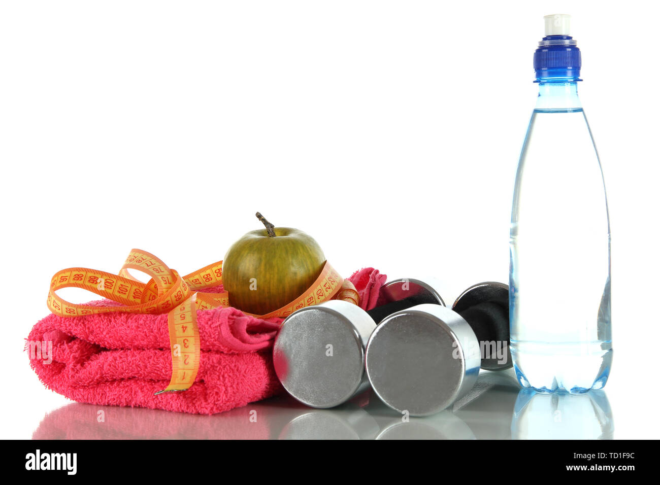 Composition of dumbbells,apple,towel,bottle of water and centimeter ...