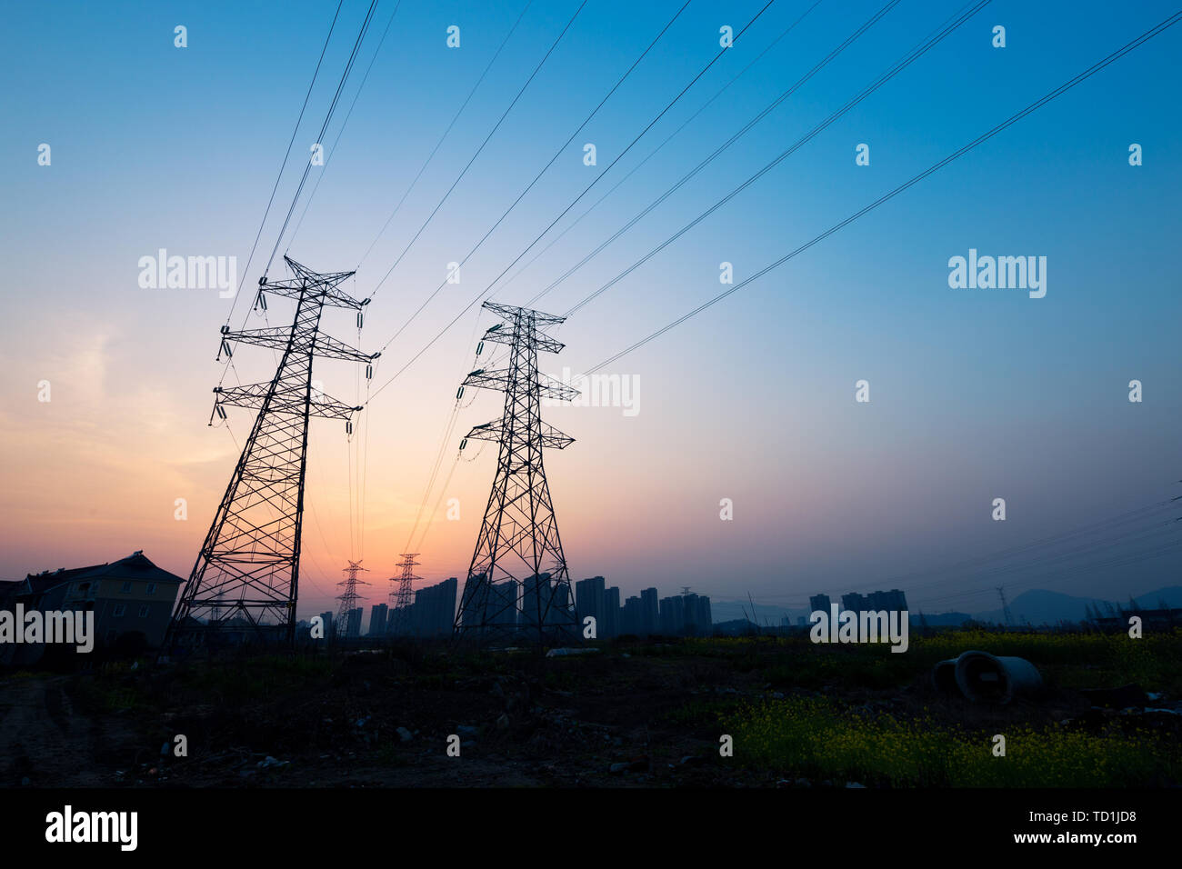 Pylons in blue sky at sunrise Stock Photo - Alamy