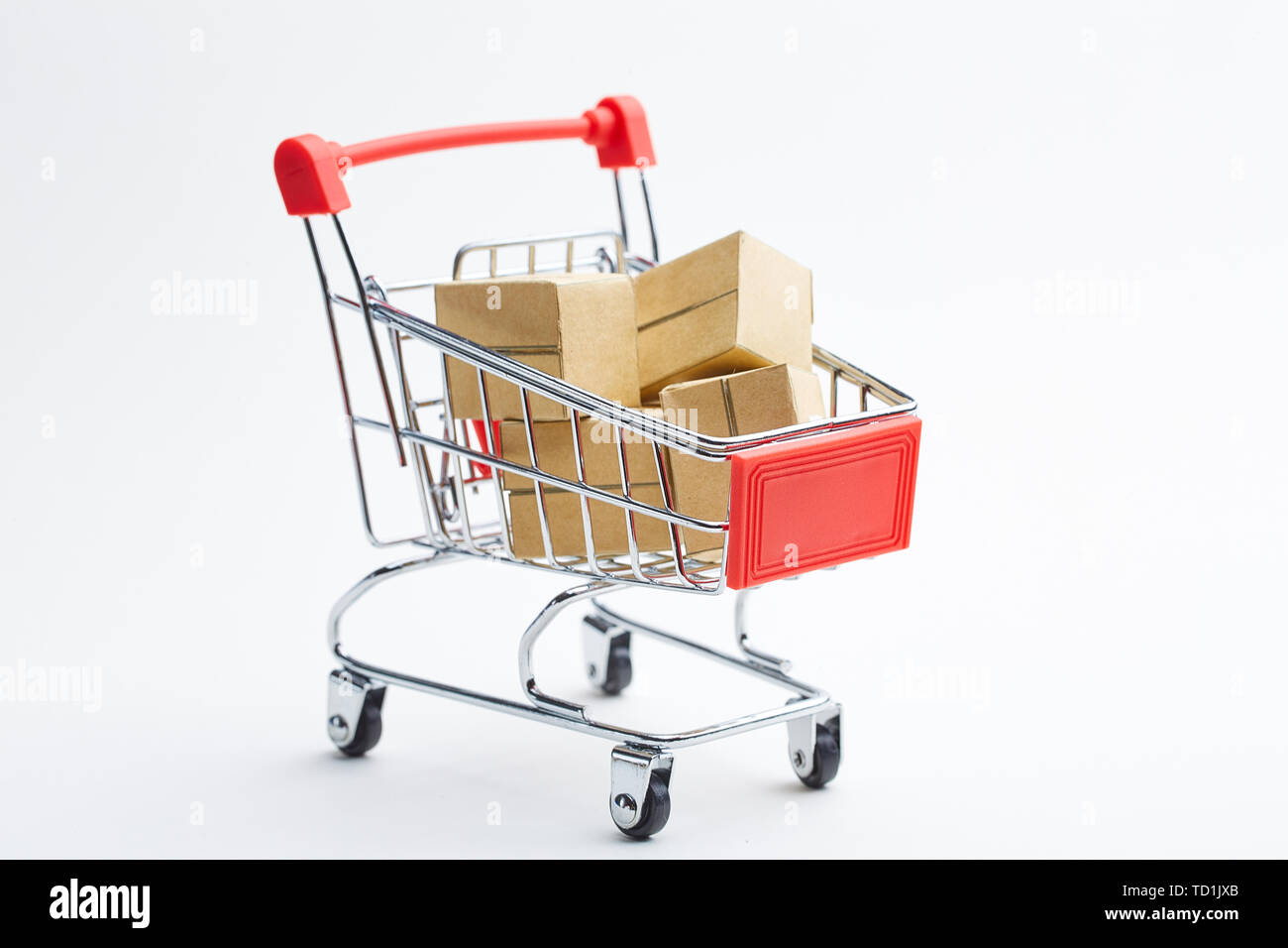 Little shopping cart and courier box on the keyboard Stock Photo - Alamy