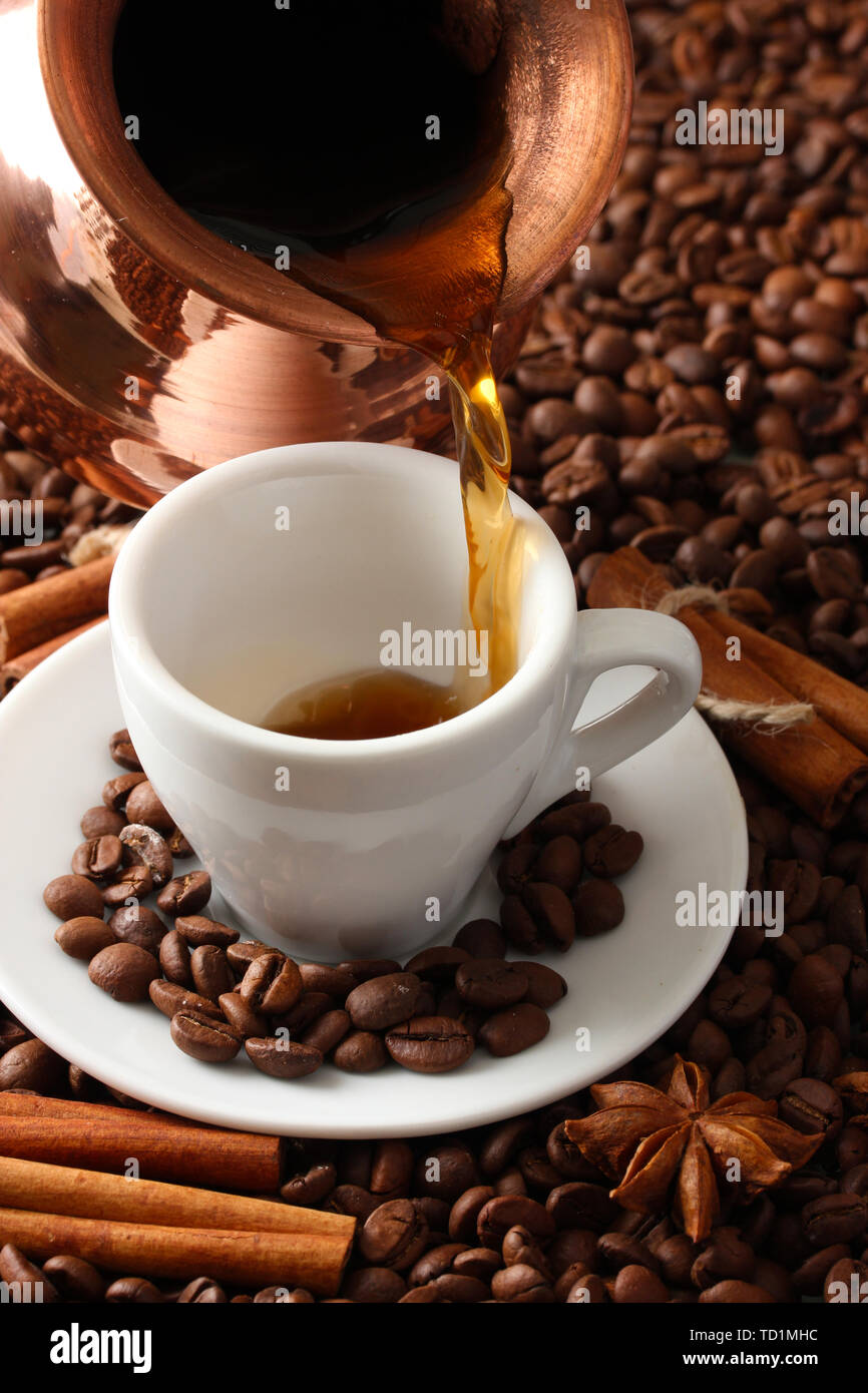 Cup and pot of coffee on coffee beans background Stock Photo - Alamy