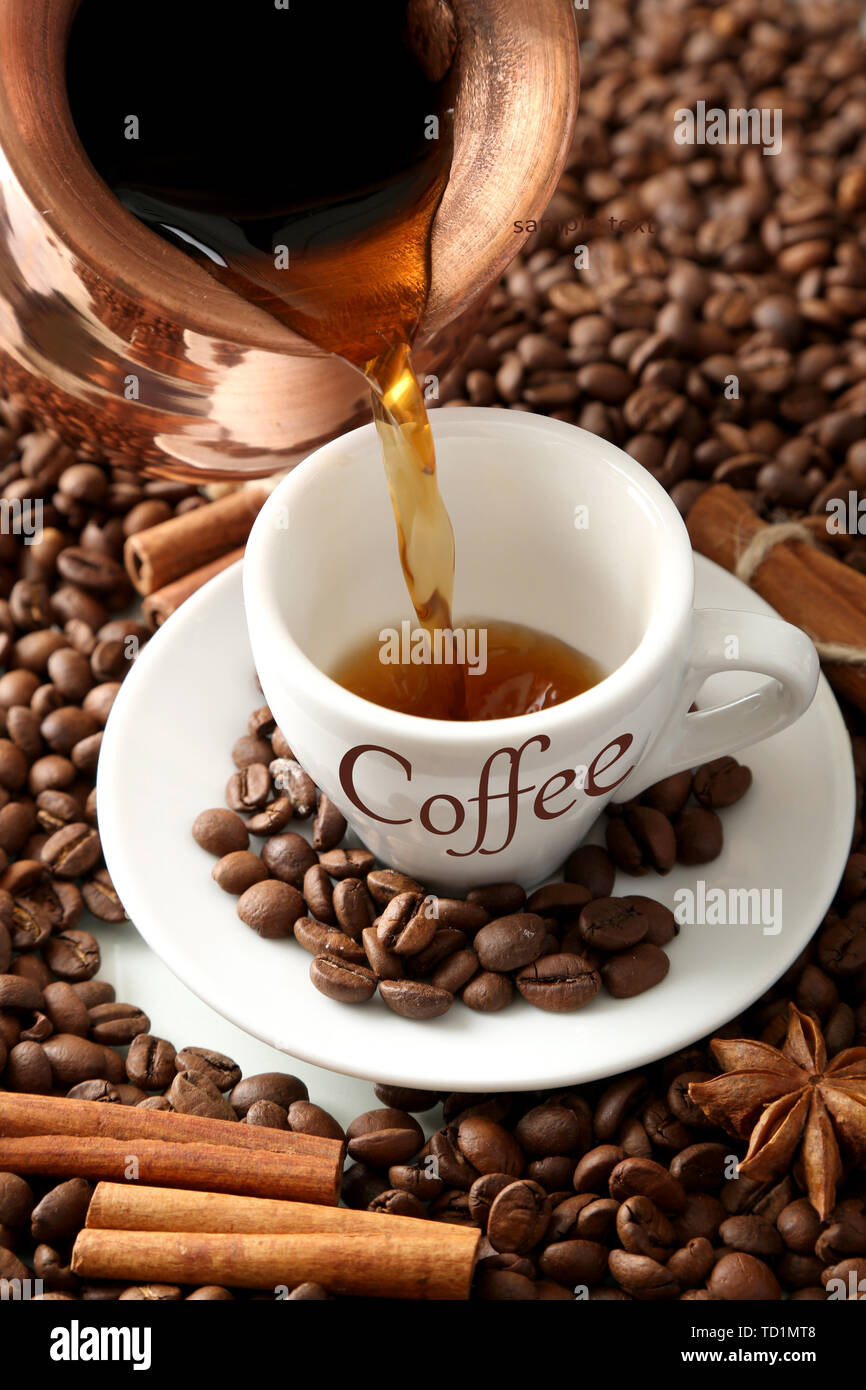 Cup and pot of coffee on coffee beans background Stock Photo - Alamy