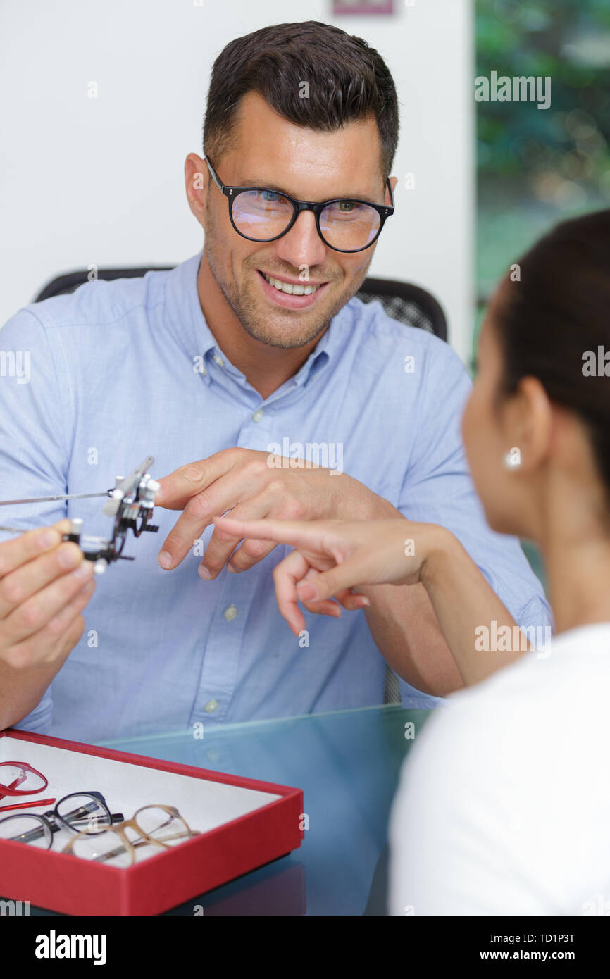 joyful friendly optometrist offering you eye test glasses Stock Photo ...