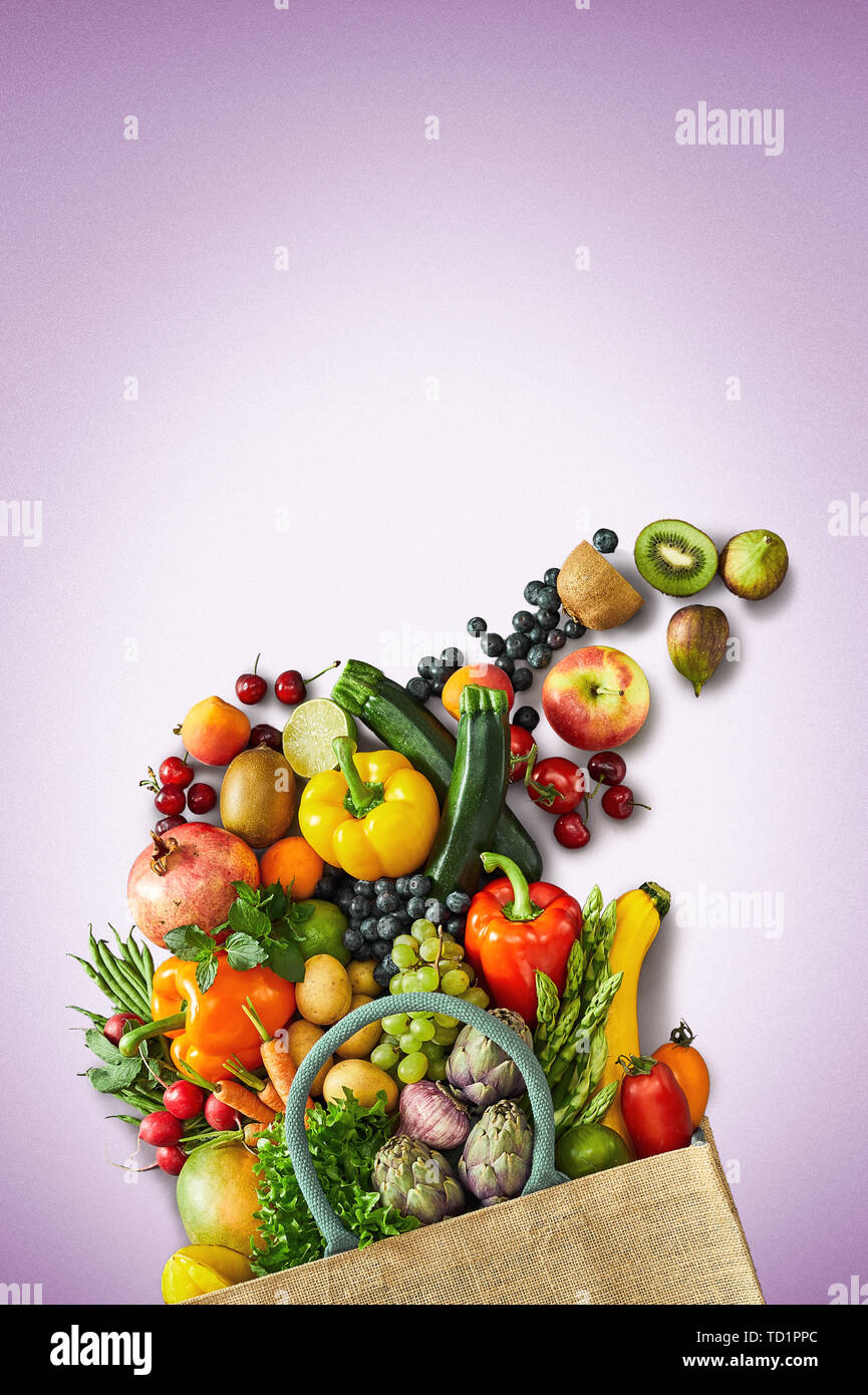 Massive assortment fallen vegetables and fruits rolling out from bag ...