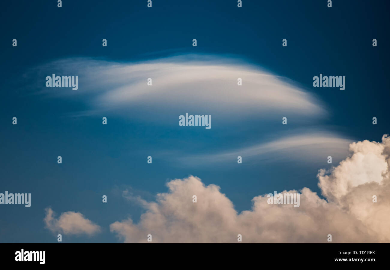 Rare Lenticular cloud Altocumulus lenticularis on top of a cumulus ...