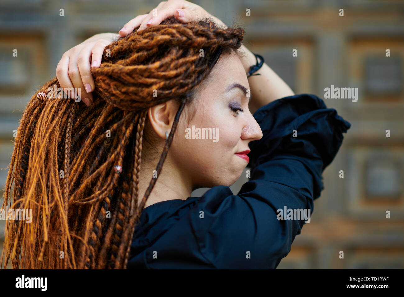 dreadlocks closeup, fashionable girl posing at old wooden door ...