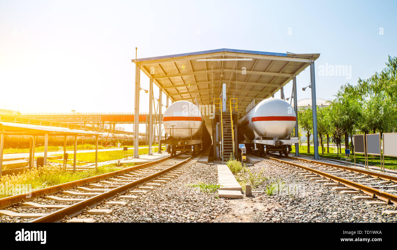 Railroad with tank train at sunrise Stock Photo - Alamy